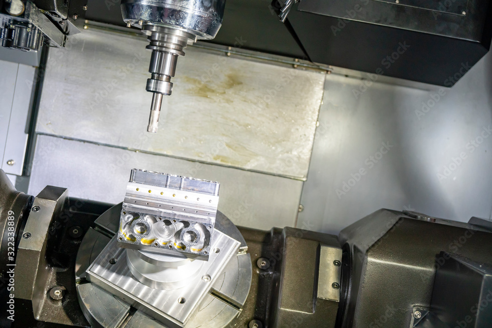 The 5-axis CNC milling machine cutting the aluminium V8 engine block by ...