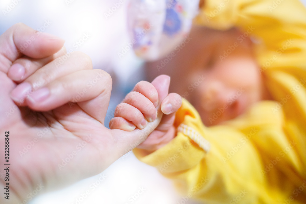 Newborn baby touching his mother hand, Baby holding finger of his ...