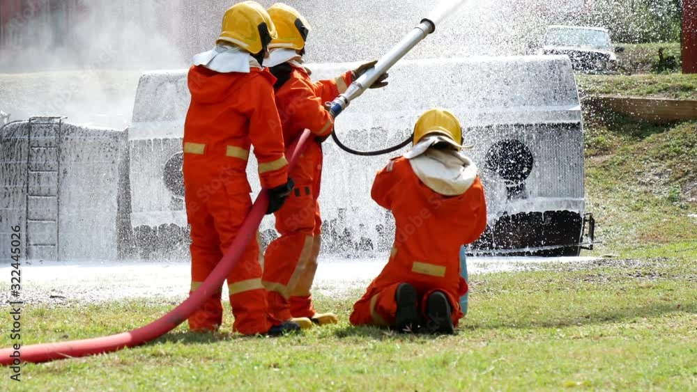 Firefighter fighting with fire flame protection property. Fireman wear ...