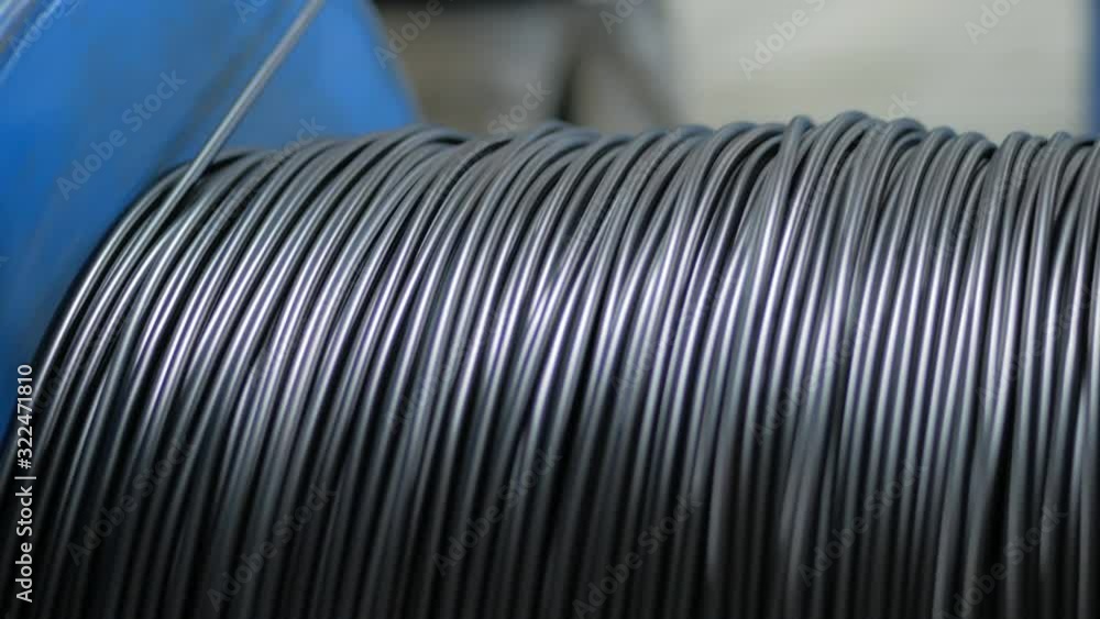 Winding cable on a rotating coil. Production of electric cable. Stock ...