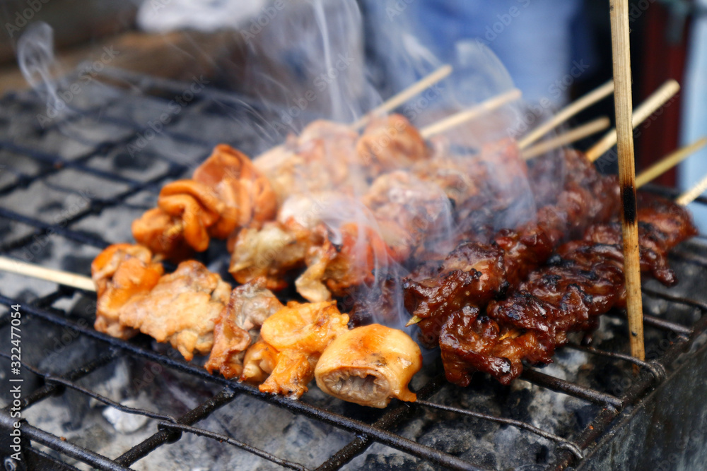 Grilled pork intestine in barbecue sticks sold at a street food stall ...