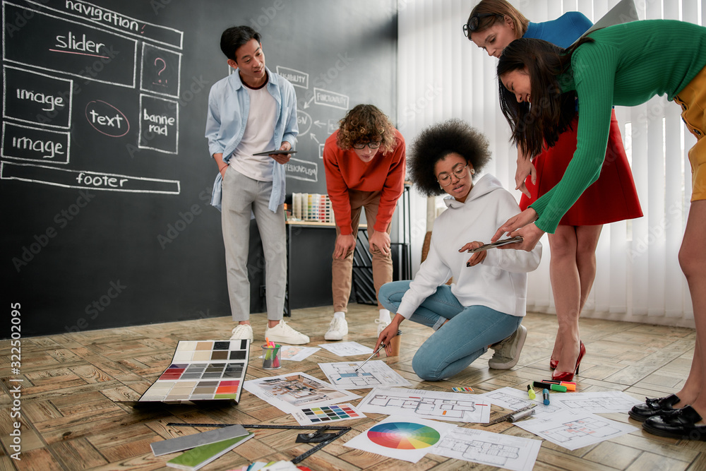 Team job. Group of professional team of interior designers discussing ...