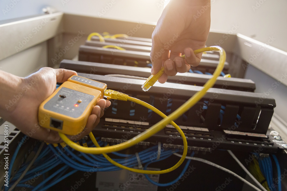 hand with network cables connected to servers in a datacenter,equipment ...