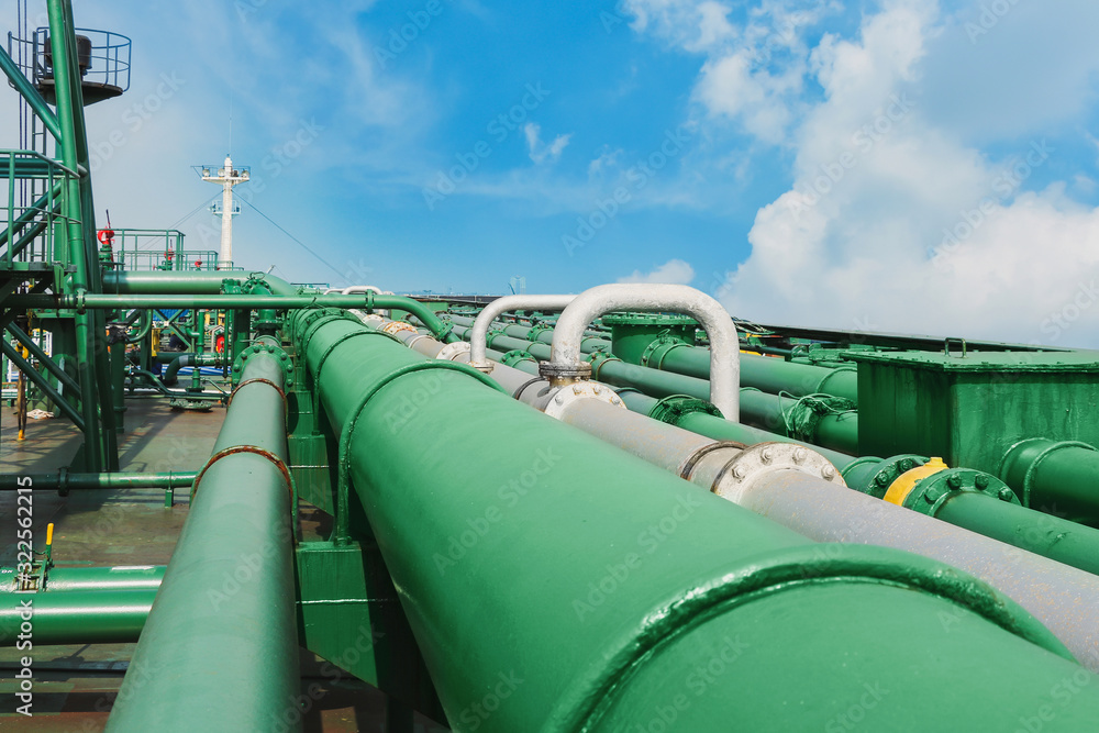 Green pipe line system connect on Oil tanker ship moored in shipyard ...