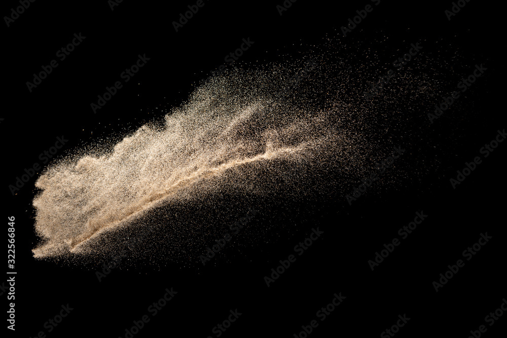 Brown colored sand splash.Dry river sand explosion isolated on black ...