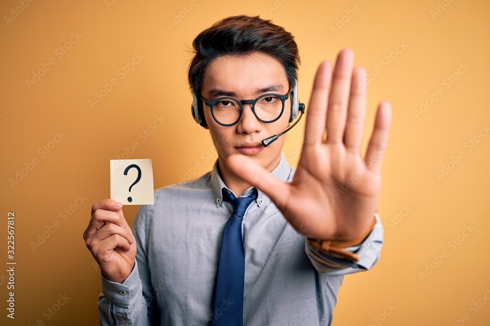 Young handsome chinese call center agent man holding paper with ...