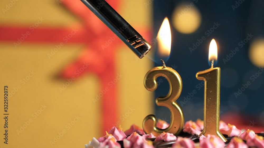 Birthday cake number 31 golden candles burning by lighter, background ...