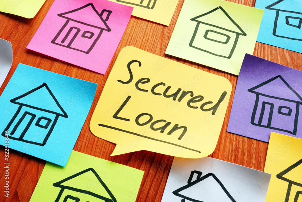 Secured loan handwritten sign on the sheet. Stock Photo | Adobe Stock