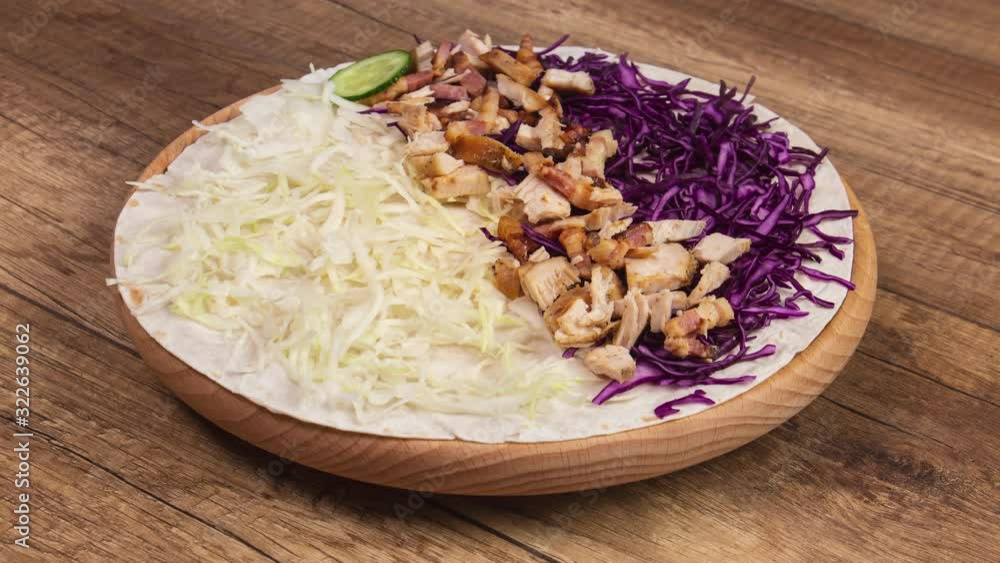 Making a kebab or gyros - a traditional sandwich wrapped in wheat wraps ...
