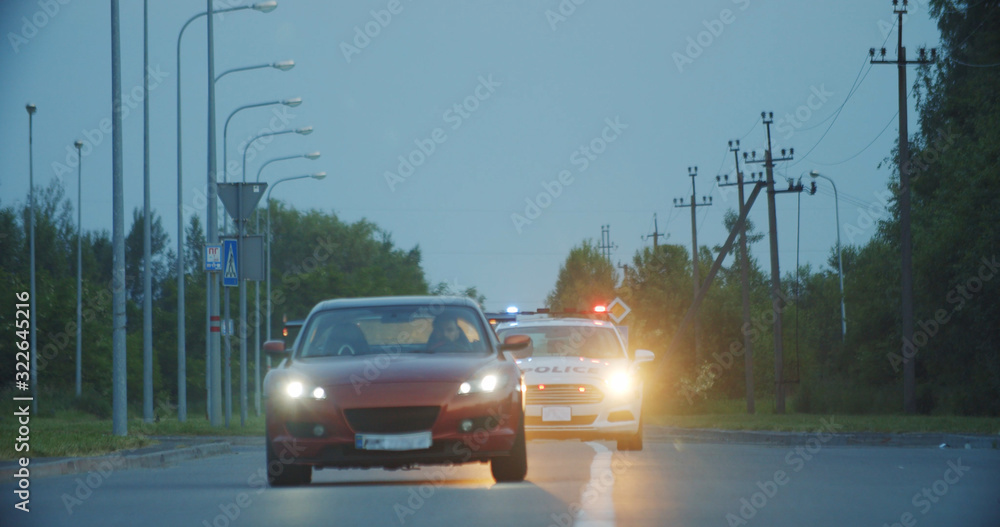 High speed police pursuit on highway. View of cop patrol car chasing a ...