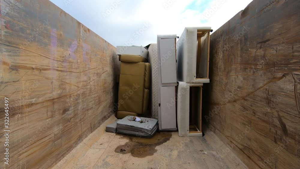 Smooth forward movement inside a skip (a large, open-topped waste ...