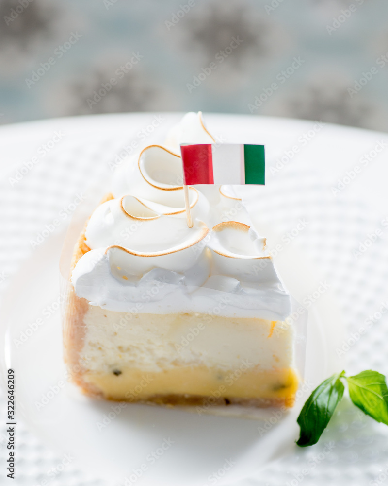 slices of white puff cake with meringue and topper of the italian flag ...