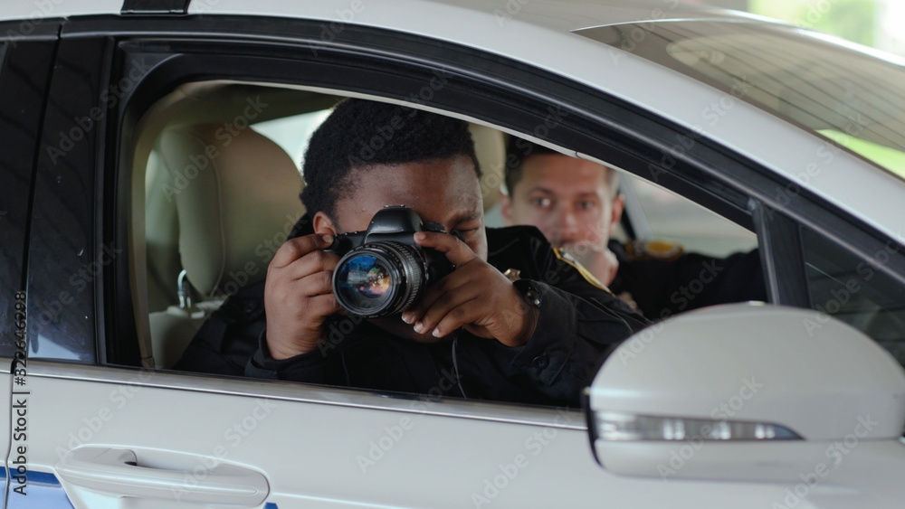 Serious two men cops sitting in patrol car take photo accepting ...
