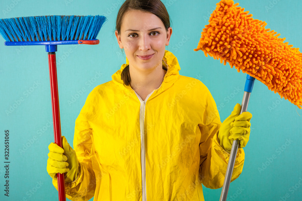 Beautiful woman cleaning lady smiling in a yellow suit cleaner with a ...