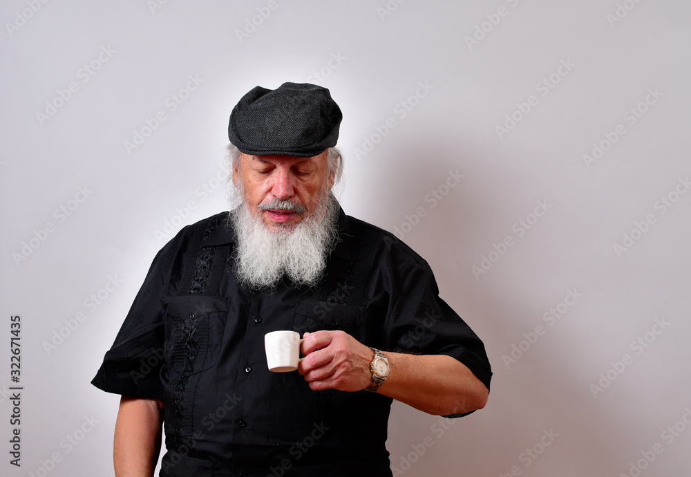 Old man enjoying his cup of expresso..Happy old man enjoys his coffee ...