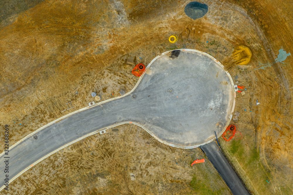 Aerial view of a paved dead end at a new construction site before any ...