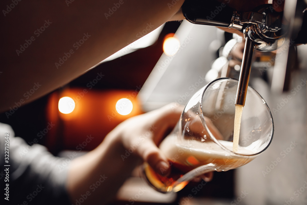 Light Draft cold beer pour in glass from crane in pub Stock Photo ...