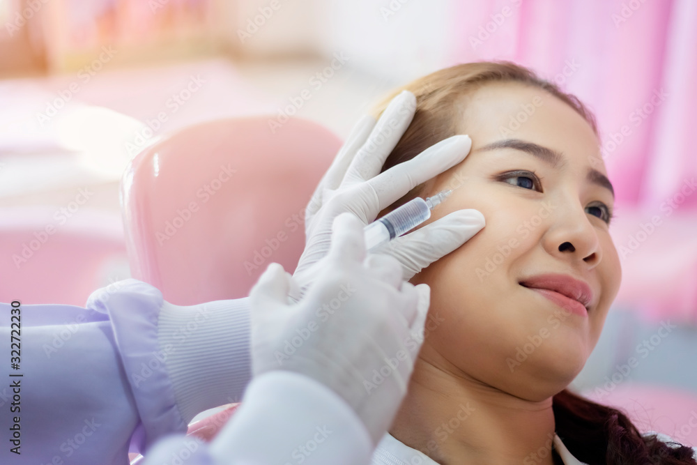 Beautiful women are injecting Botox in the face. The medical specialist ...