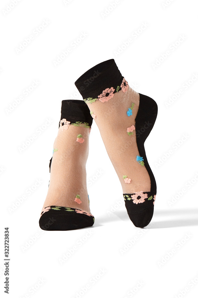 Cropped shot of female feet on tiptoe in flesh-colored nylon sheer ...