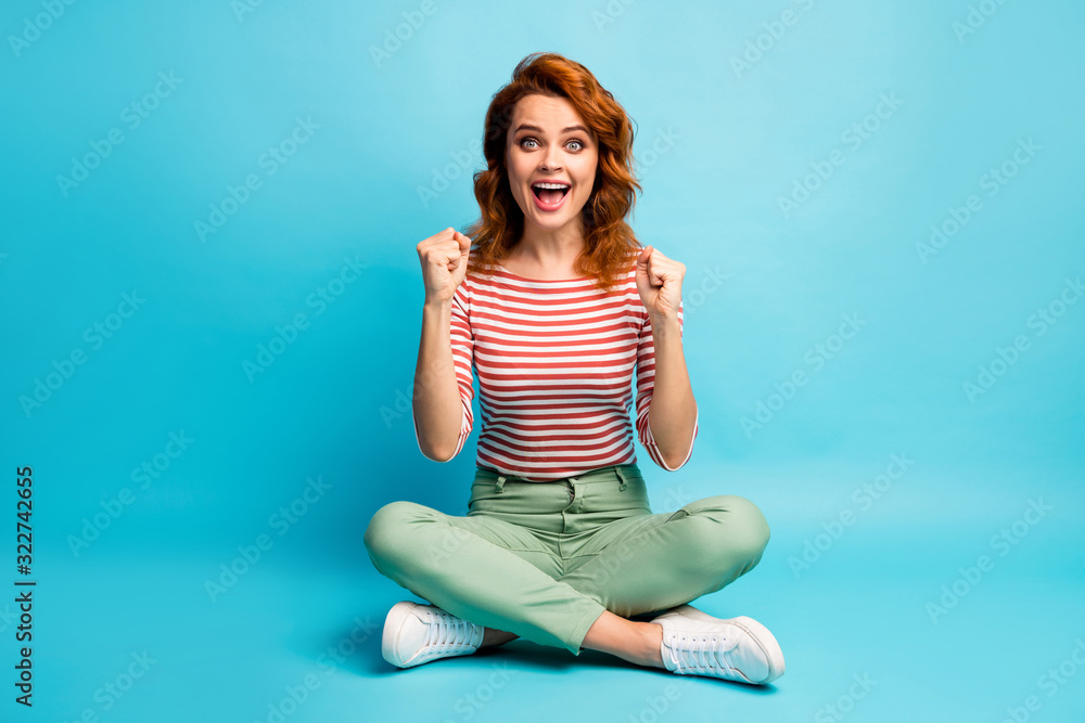 Full length photo of excited woman sit legs crossed celebrate her ...
