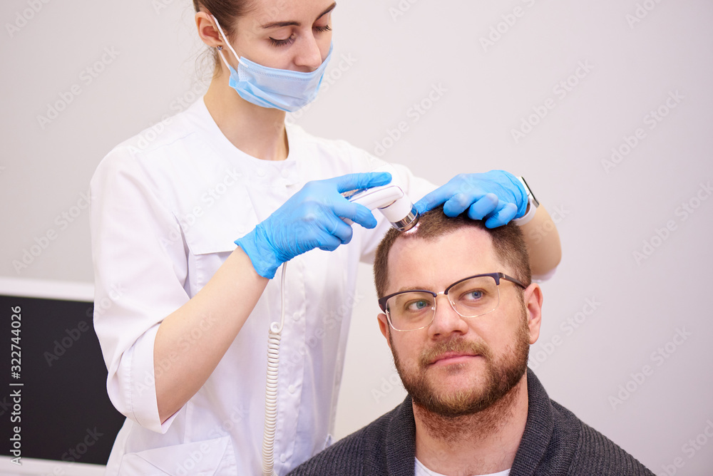 Microscopic examination of the hair and skin of the scalp. Stock Photo ...