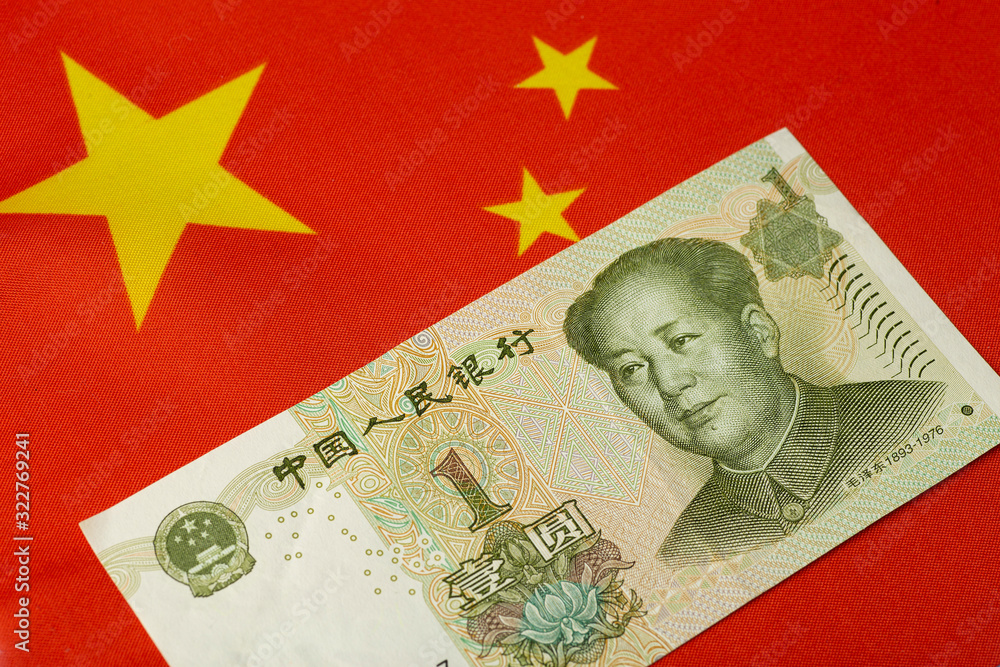 Chinese Yuan against the backdrop of the Chinese flag. One yuan ...