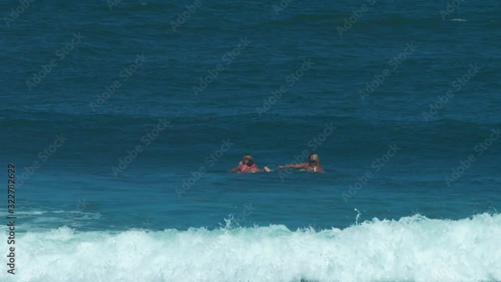 Surfer girl in bikini interring the water in Bali Slow motion cinematic ...