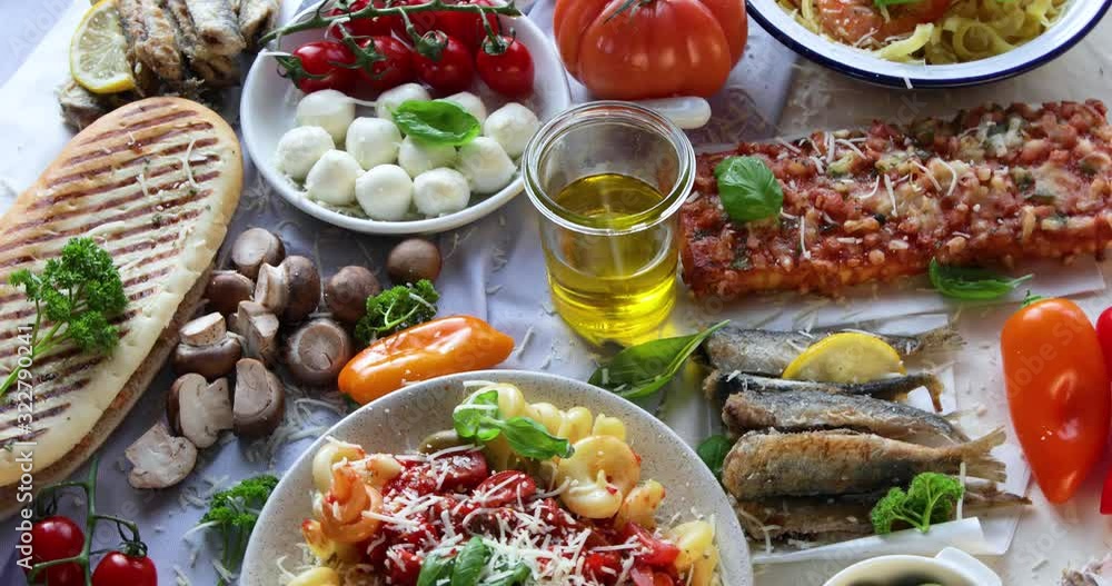 Traditional Italian foods with pizza, pasta, olives, vegetables ...
