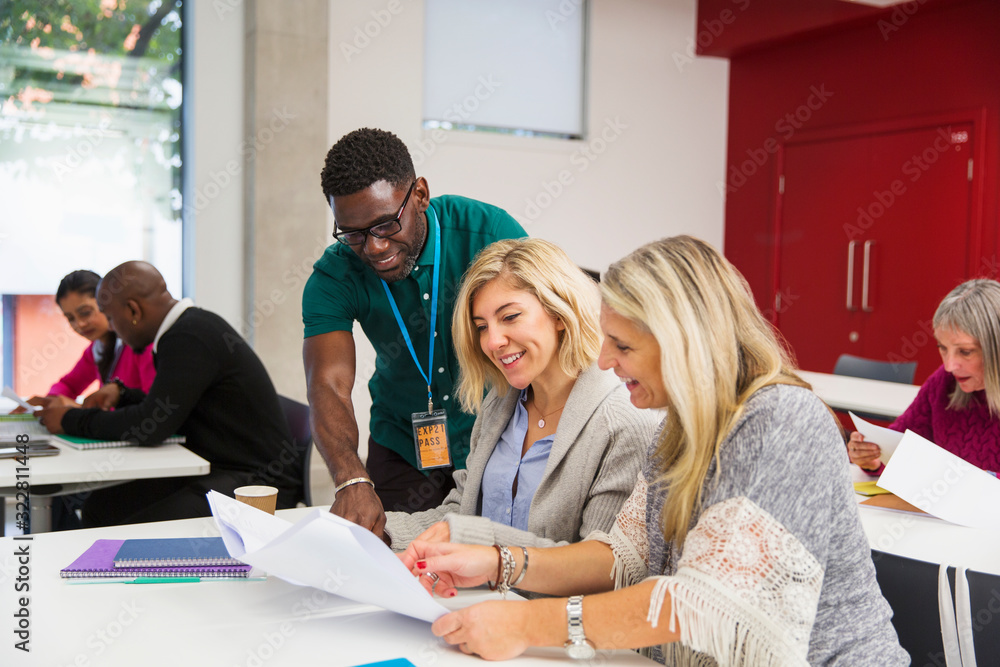 Community college instructor and students talking in classroom Stock ...