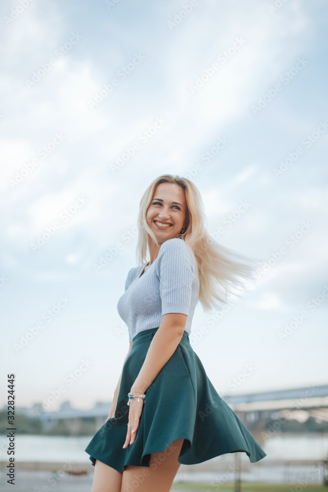 Woman twirling her skirt in summer on sky background Stock Photo ...