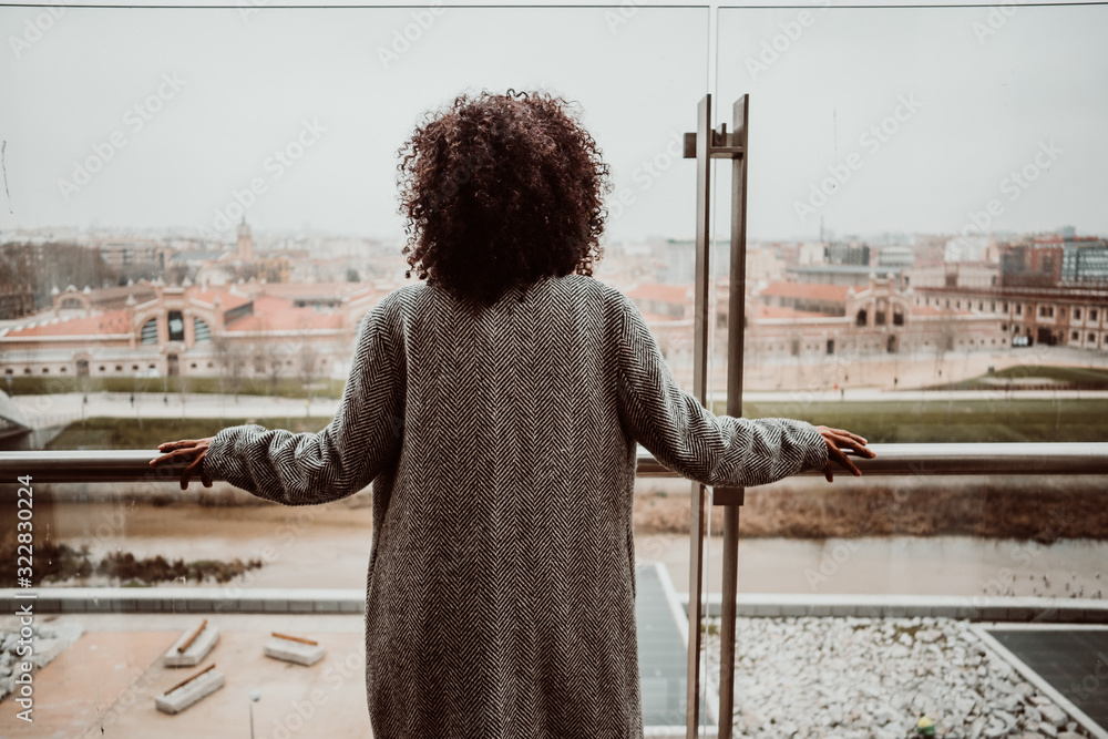 .Beautiful African American woman looking backwards out the window of a ...