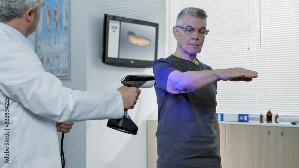 doctor scanning elbow patient with a hand scanner 3d to capture data to ...