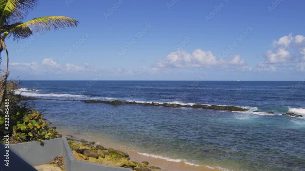 Ocean view landscape from shore - blue waves and stones in water, San ...