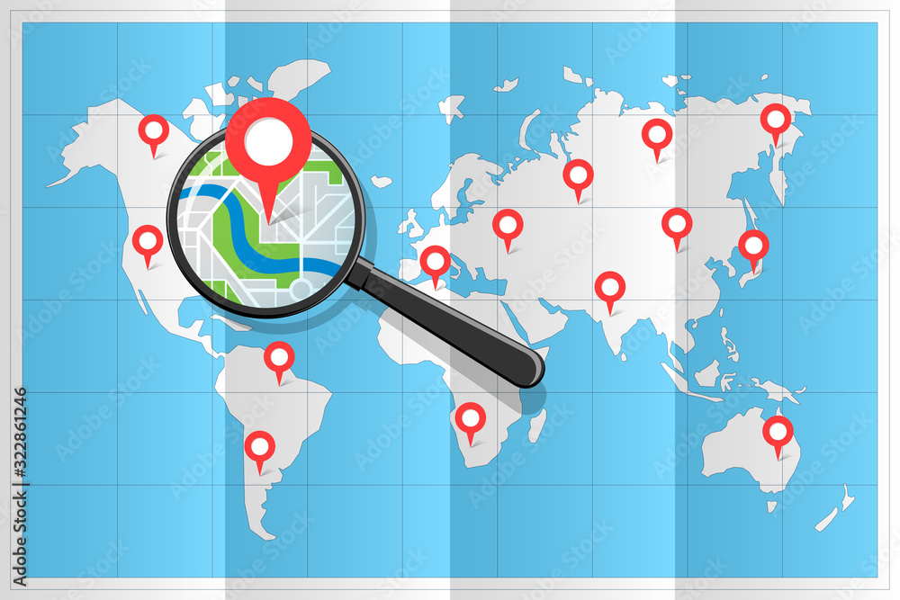 Magnifying glass over folded world map searching destination place for ...
