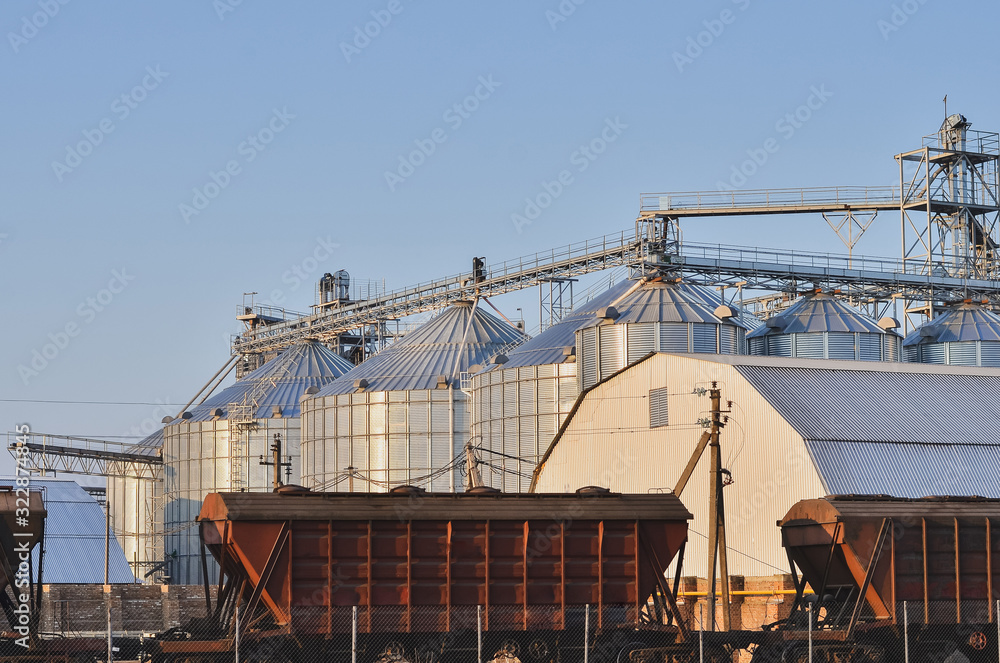 Loading railway carriages with grain at grain elevator. Stock Photo ...