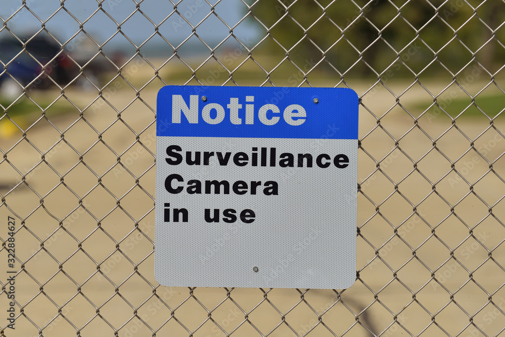 surveillance cameras in use sign on chain link fence Stock Photo ...