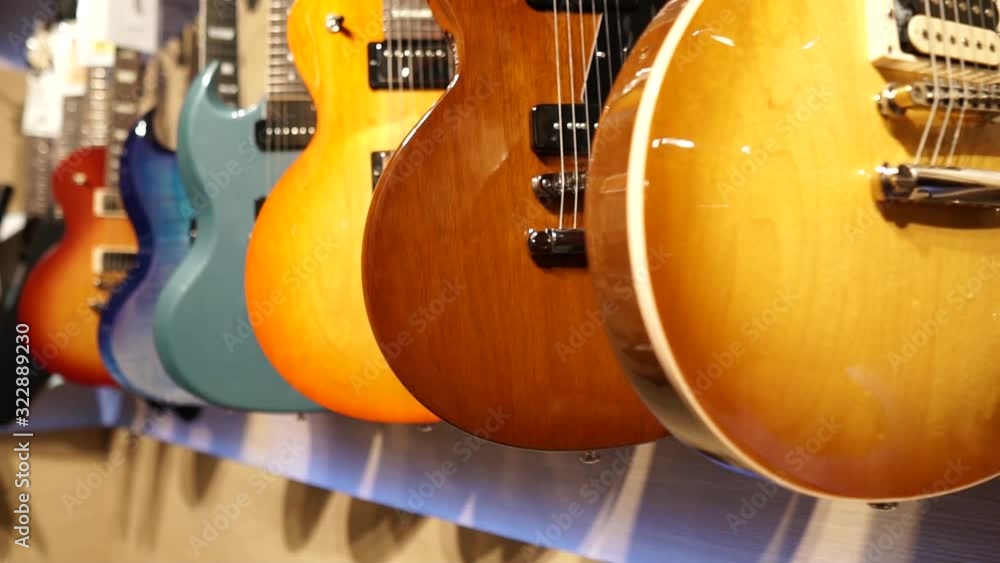 Electric Guitars hanging on los angeles store with white background ...