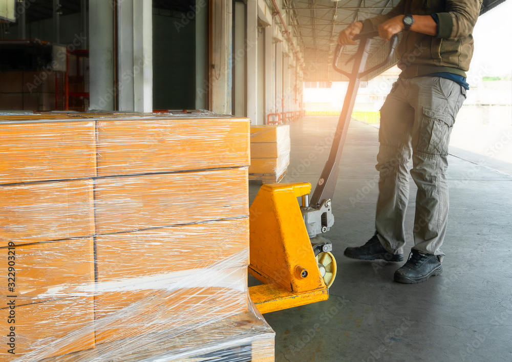 Workers Courier Using Hand Pallet Jack Unloading Package Boxes into ...