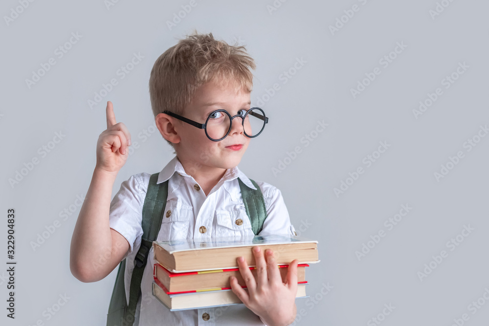 Back to school. Funny clever little blonde boyelementary school with ...