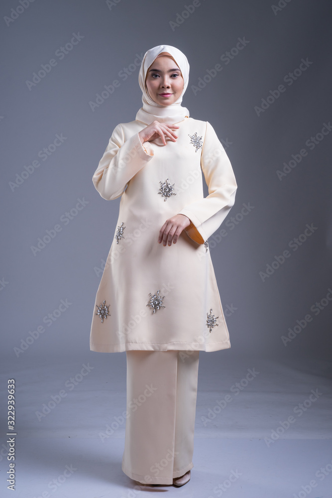 Beautiful female Muslim model wearing kurung Pahang and hijab, an urban ...