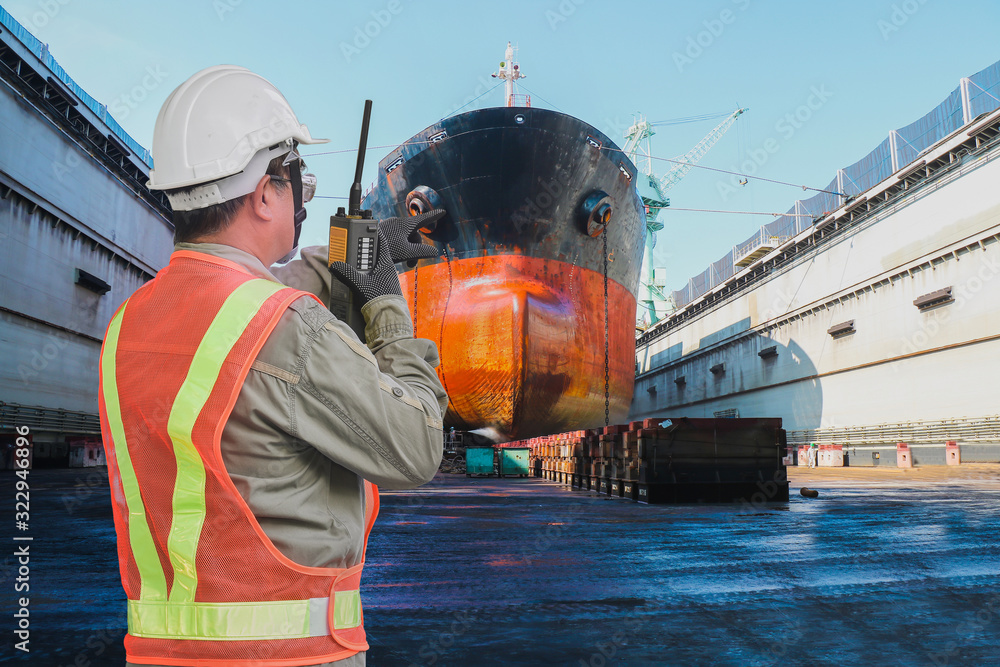 surveyor operation talkie with vessel moored in floating dock in ...