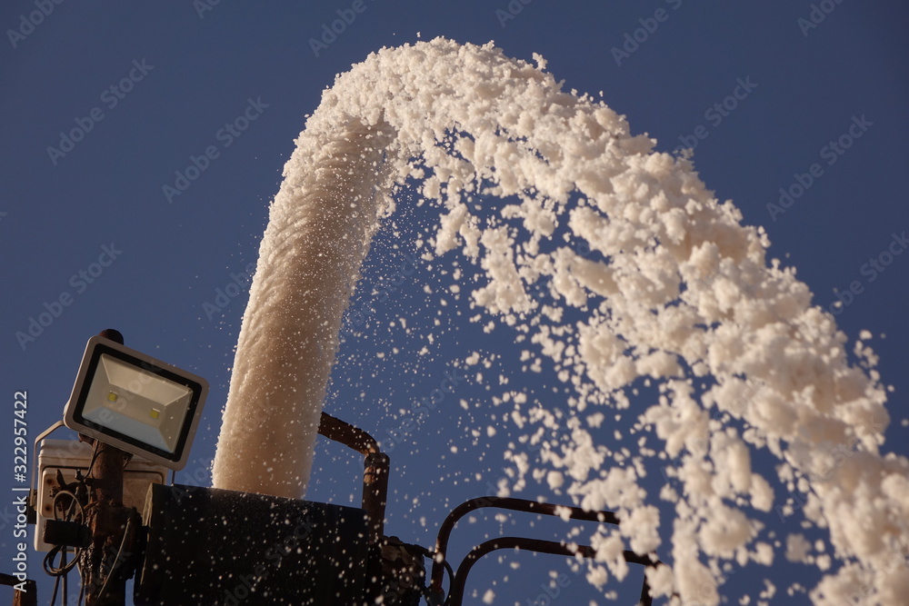Refined salt falling from an elevated conveyor belt Stock Photo | Adobe ...