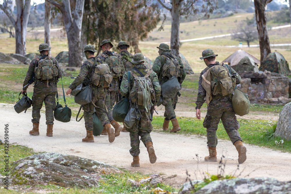 Troop of ground soldiers walking in the field Stock Photo | Adobe Stock