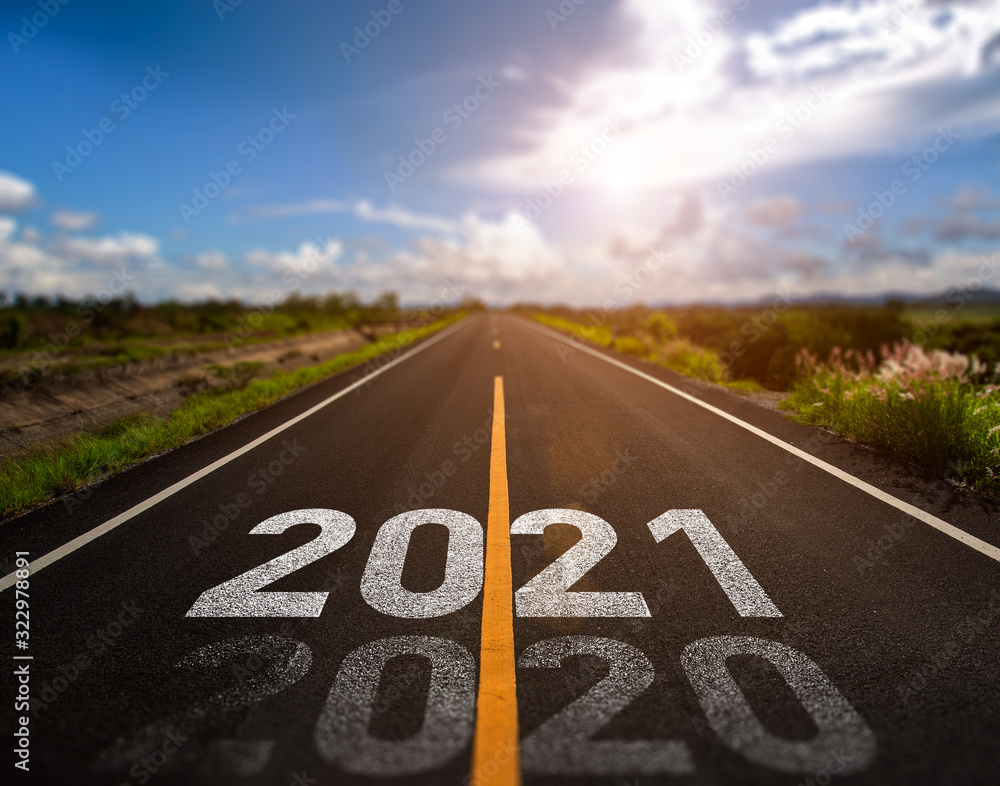 The word 2021 written on highway road in the middle of empty asphalt ...