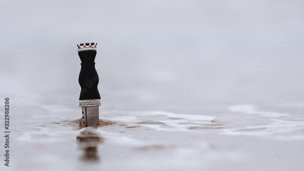 Sgian dubh Scottish blade stuck in beach sand while being washed by ...