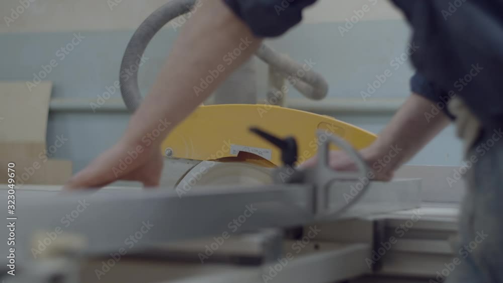 Carpenter working on a circular saw machine. Wooden furniture ...
