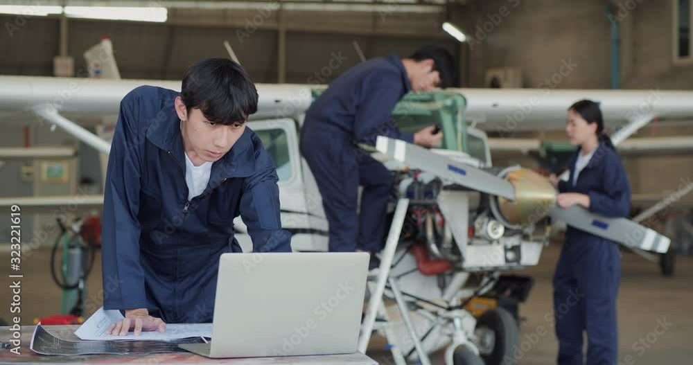 Engineers working to a large aircraft project together. Group engineers ...