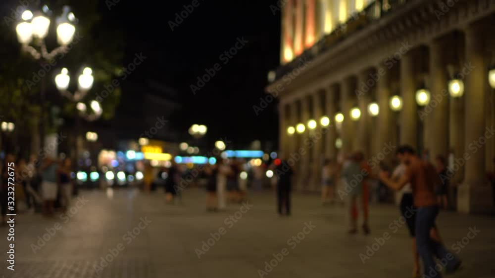 Young couple gracefully dances a ballroom dance on the square of paving ...