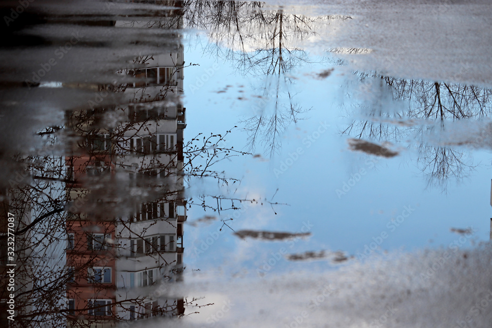 Rainy weather, reflection of residential building, trees and blue sky ...