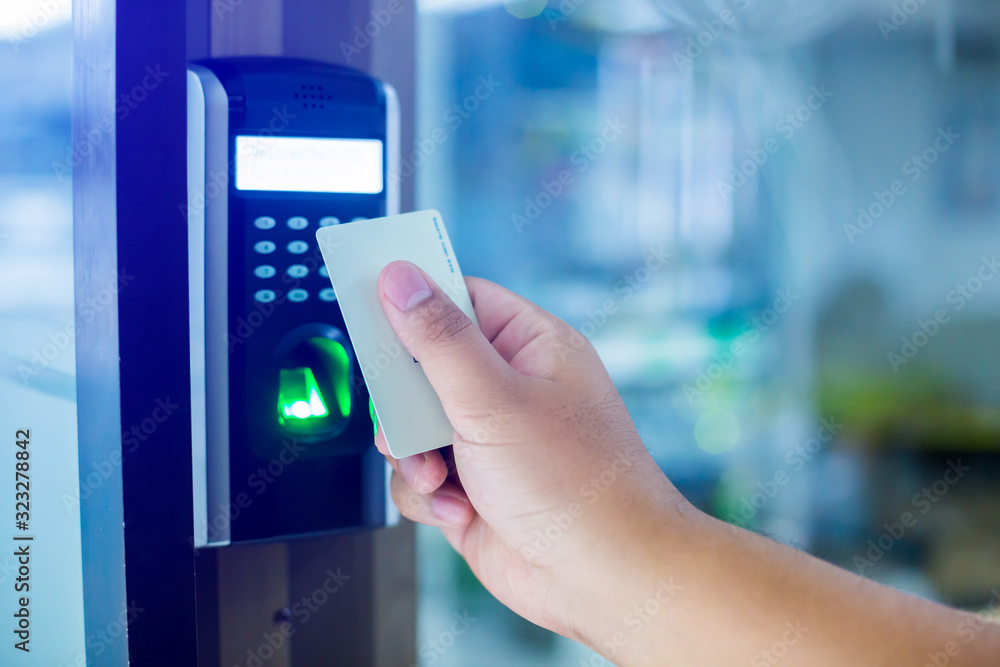 Foto de Door access control. Staff holding a key card to lock and ...